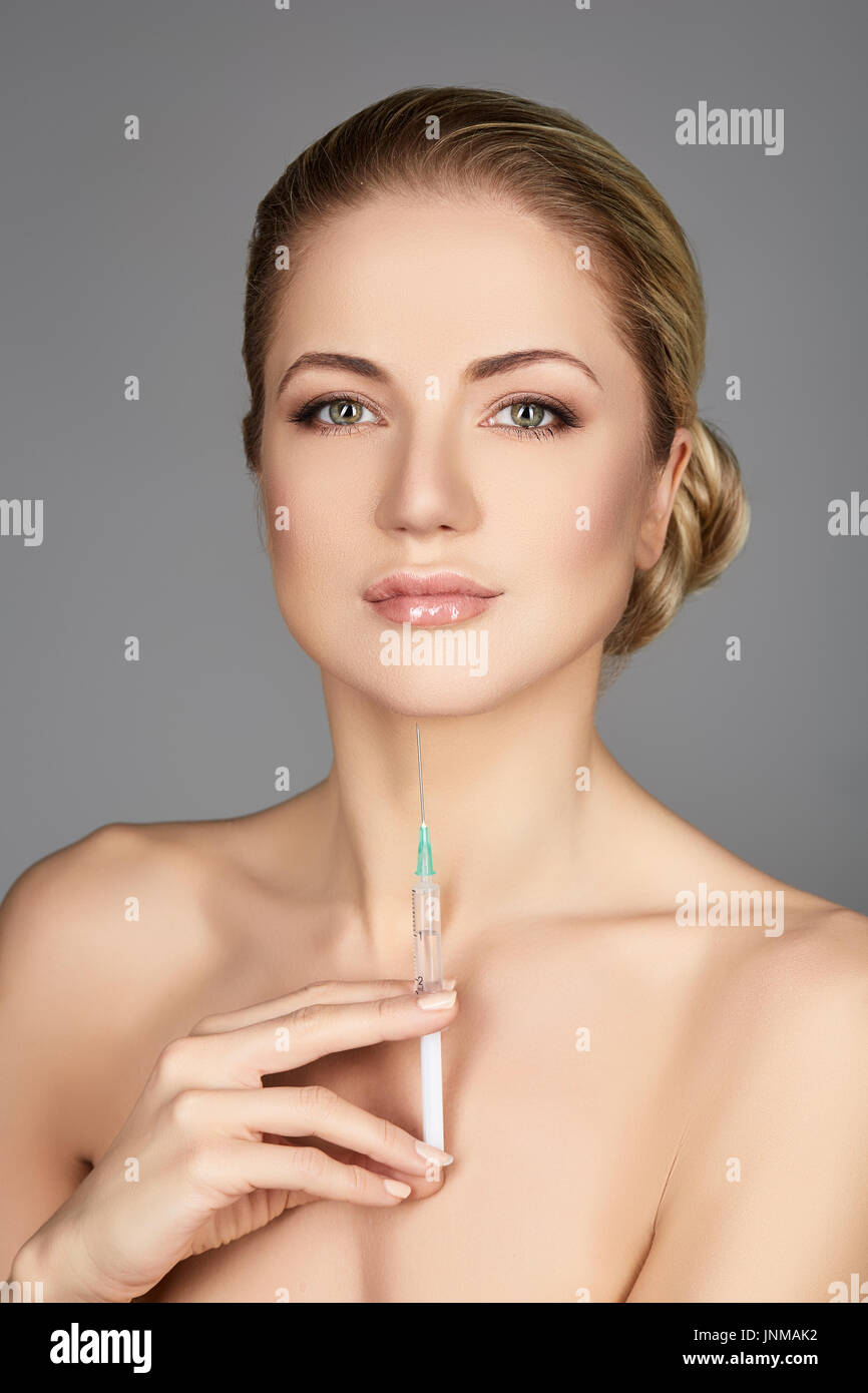 beautiful girl holding syringe Stock Photo - Alamy