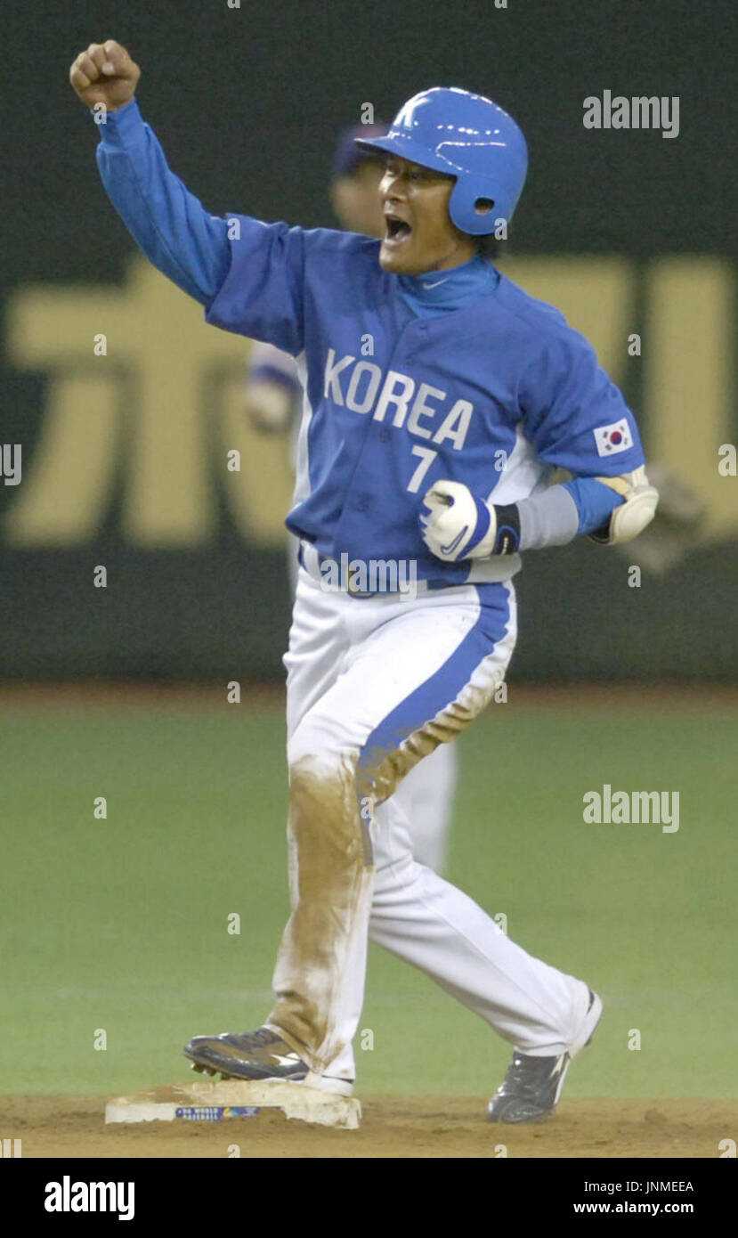 TOKYO, Japan - South Korea's Lee Jong Beom reacts after hitting an RBI ...