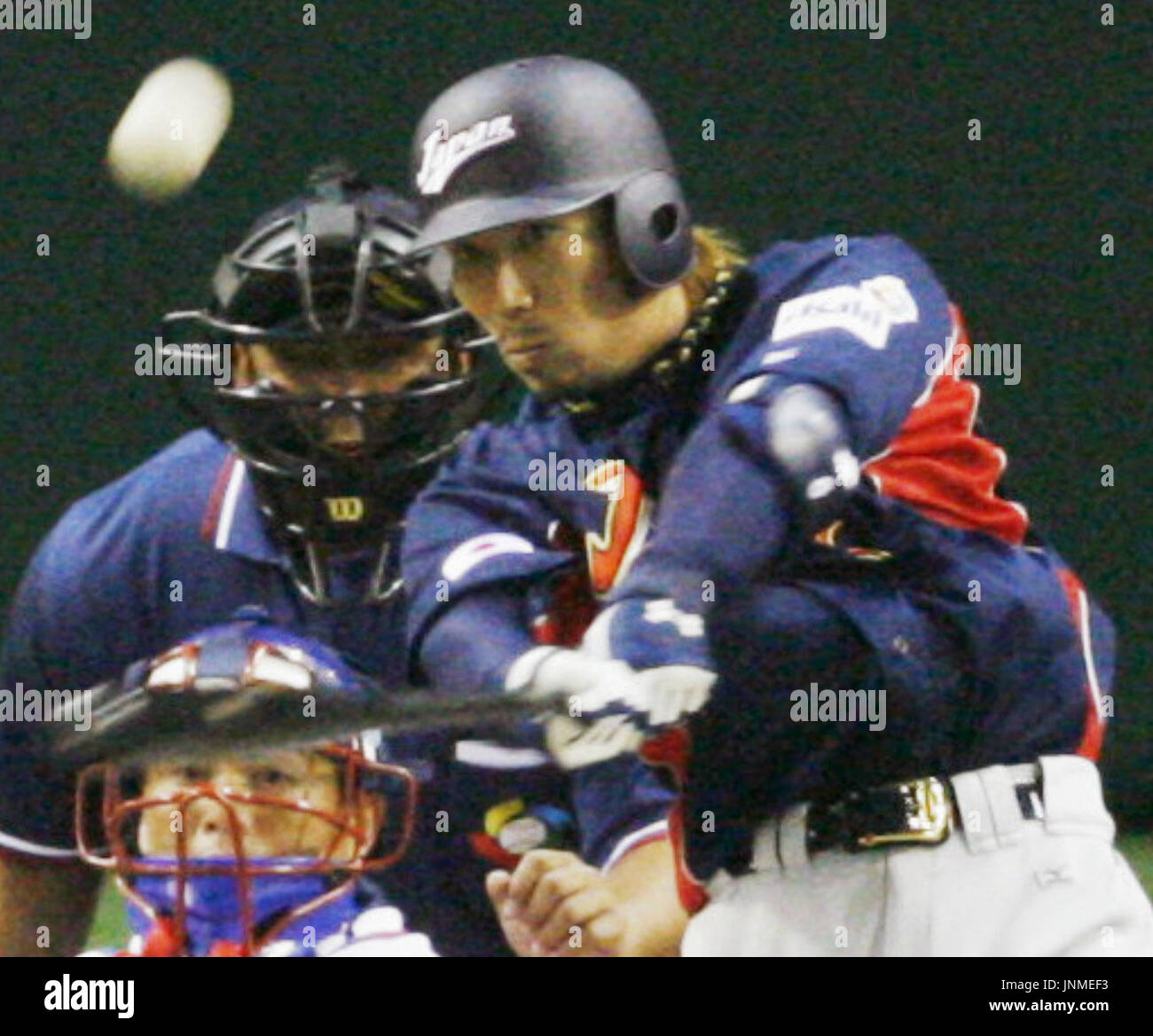 TOKYO, Japan - Japan's outfielder Hitoshi Tamura hits a three-run homer over the left-field ...