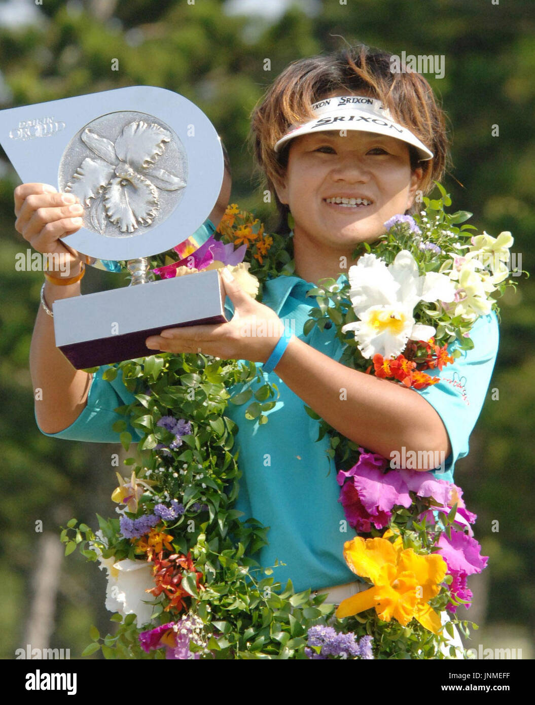 NAHA, Japan - Mikiyo Nishizuka holds up her trophy after winning the ...