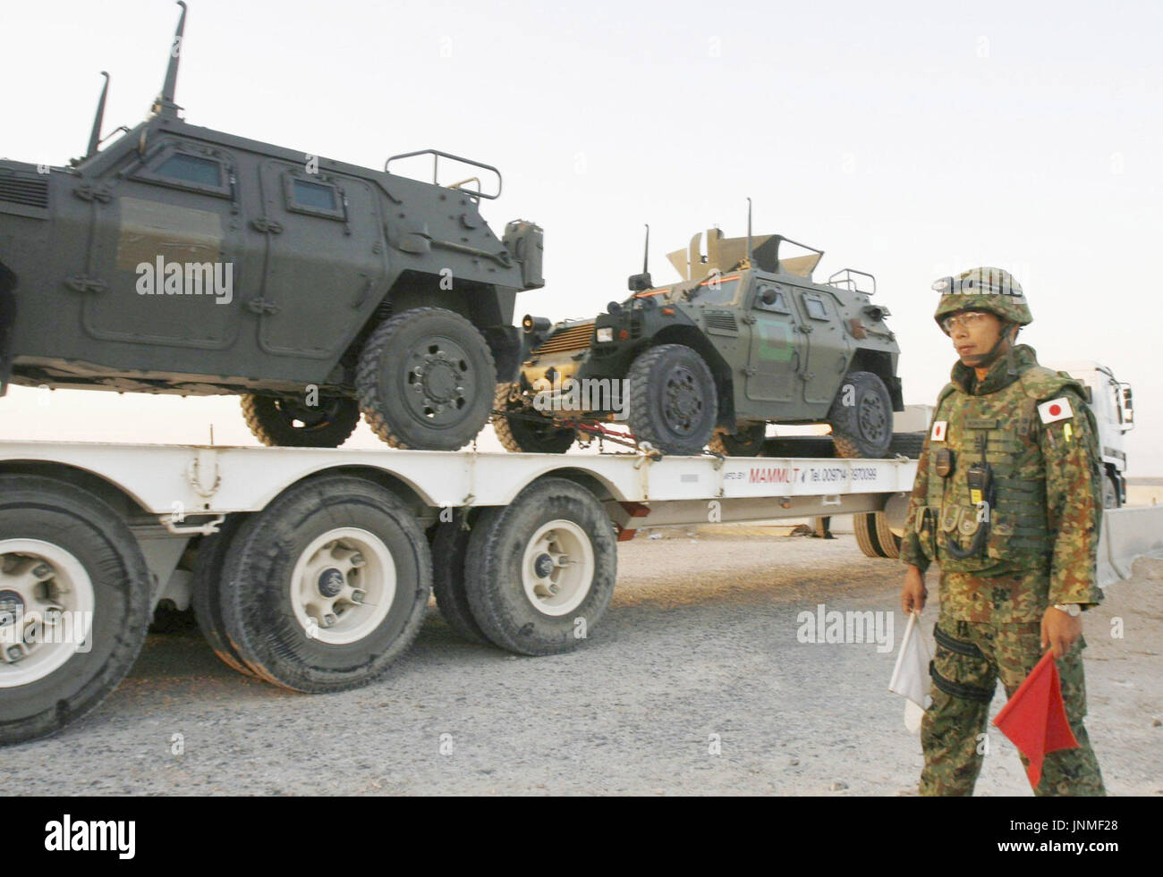 SAMAWAH, Iraq - A trailer carrying a dozen light armored trucks of ...