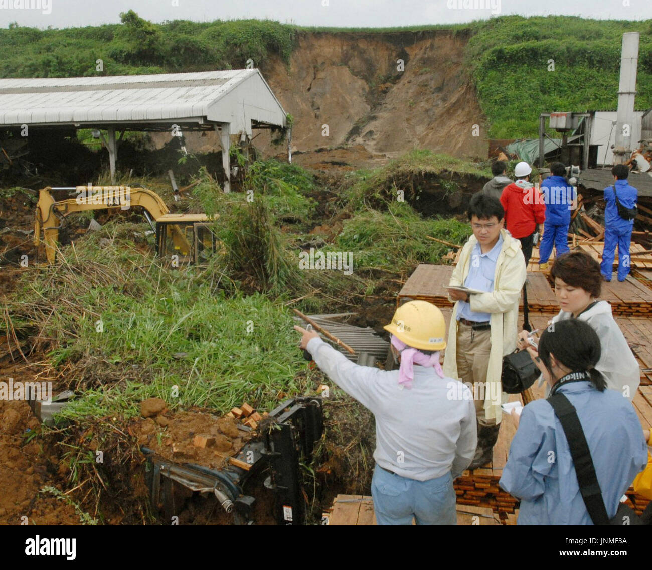 KUMAMOTO, Japan - Three persons are caught in a landslide in Yamato ...
