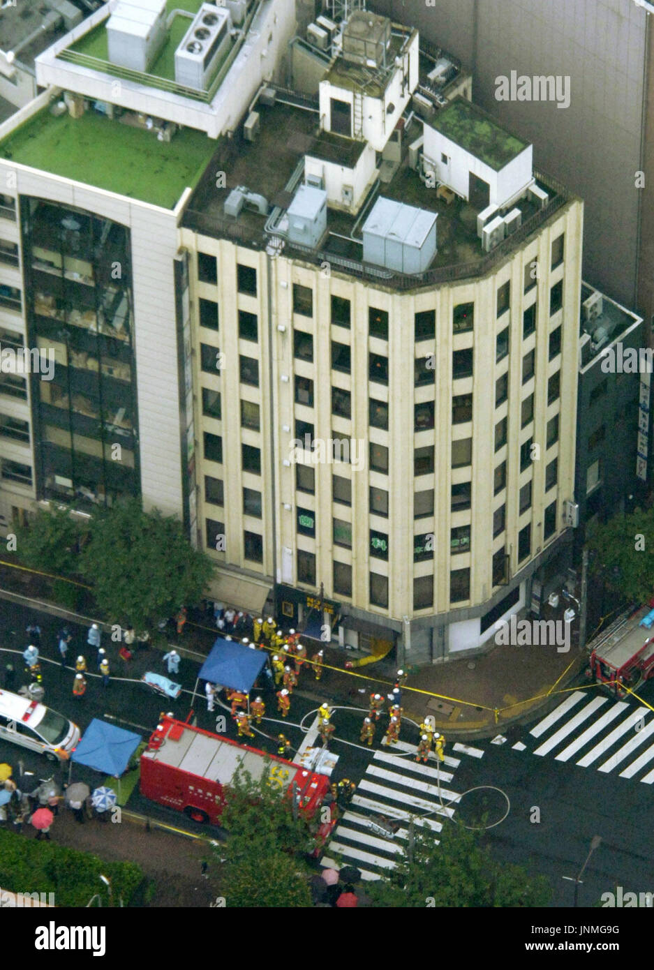 TOKYO, Japan - Rescuers work at a Japanese restaurant in a building in ...