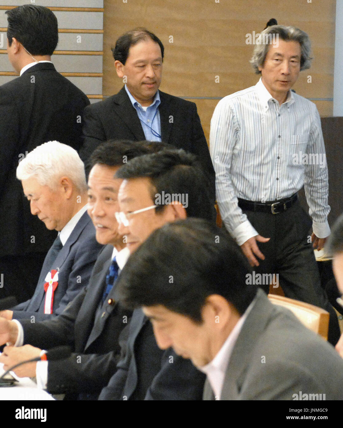 TOKYO, Japan - Prime Minister Junichiro Koizumi walks into a room to ...