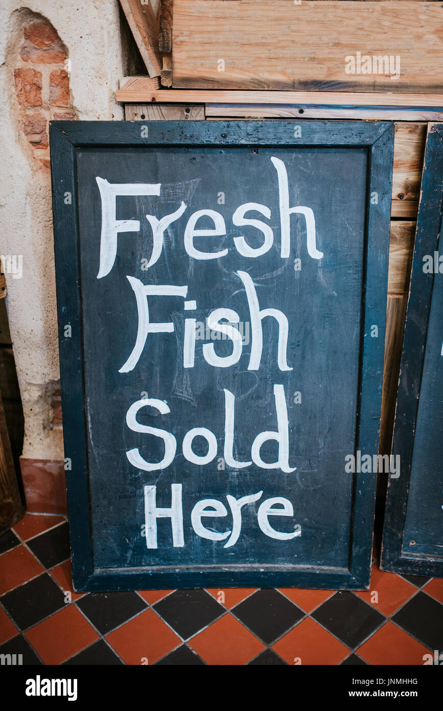 Fresh fish sold here sign Stock Photo - Alamy