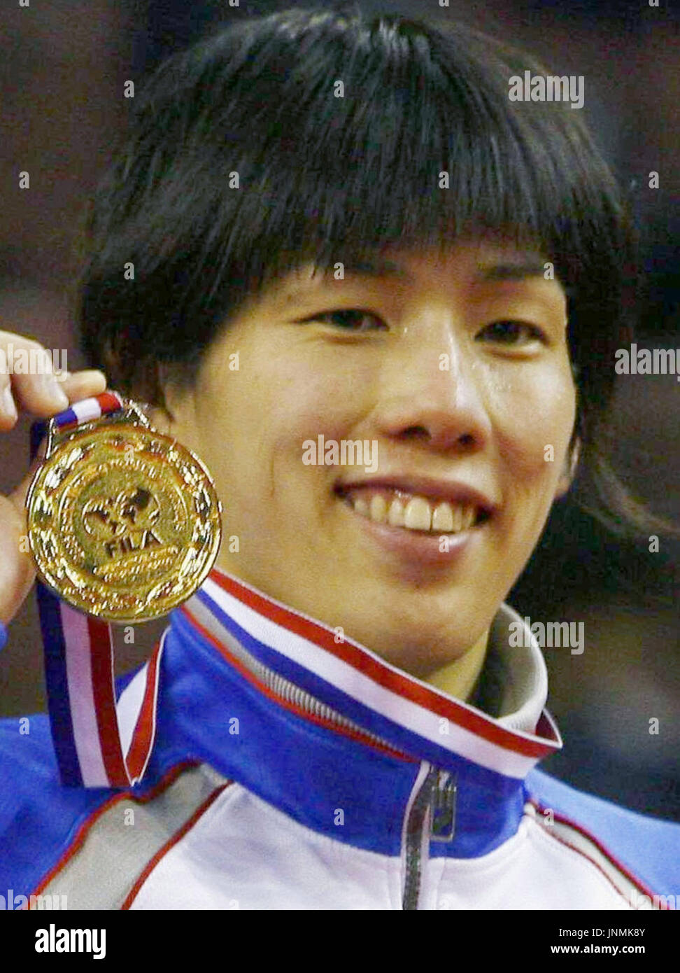 GUANGZHOU, China - Saori Yoshida of Japan holds up her gold medal after ...
