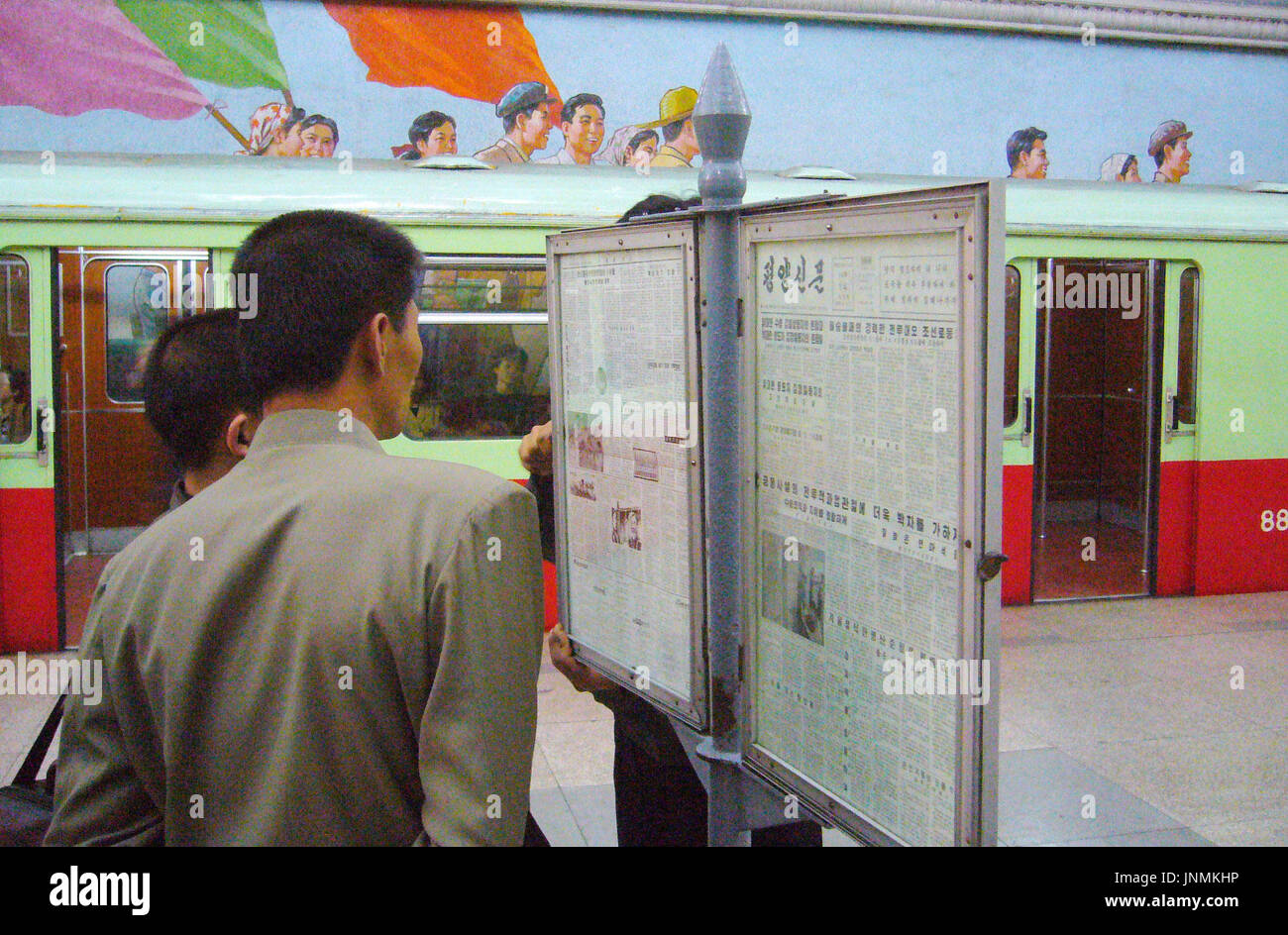 PYONGYANG, North Korea - Citizens read a newspaper put up in a subway ...