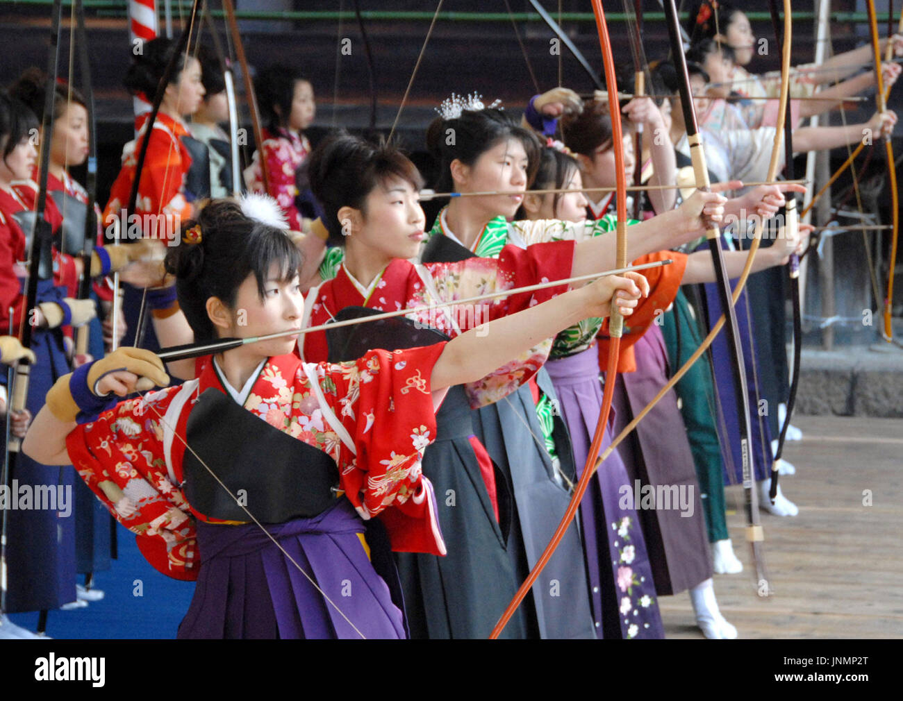 KYOTO, Japan - Young female archers dressed in kimono try to find the ...