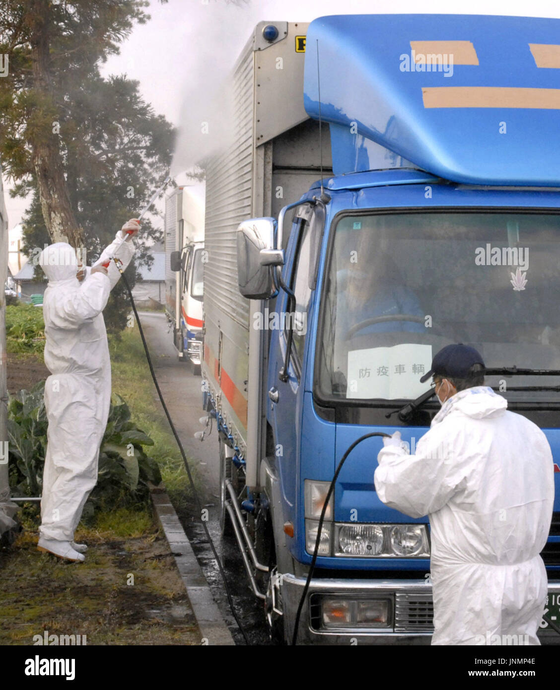 KIYOTAKE, Japan - Sanitation workers disinfect one of trucks that ...