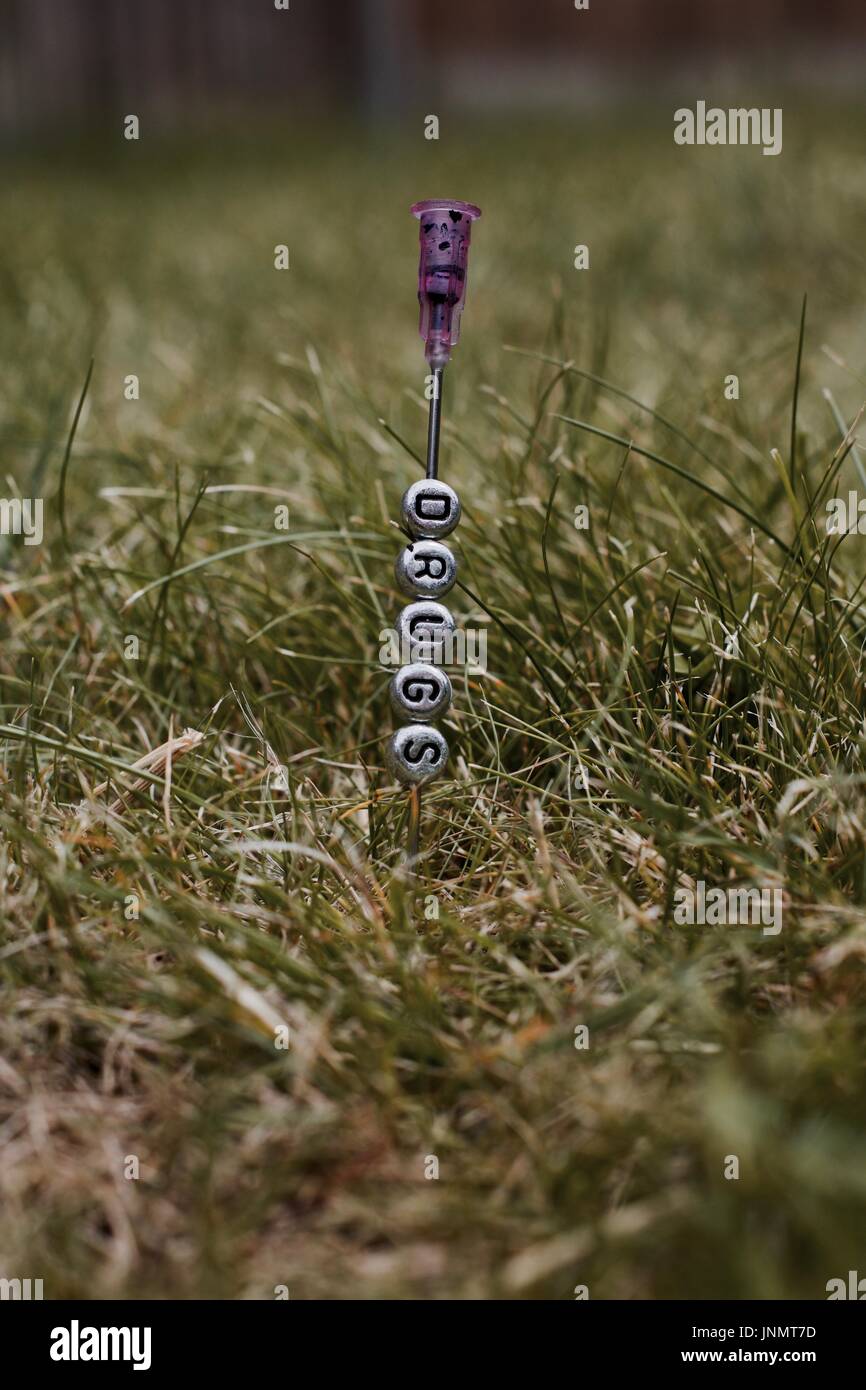 Drugs - silver pins inscription on the needle in green grass Stock ...