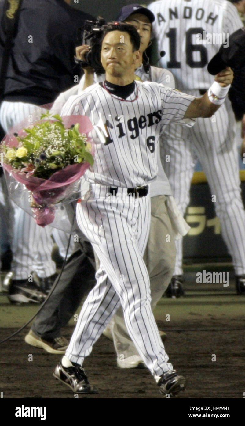 OSAKA, Japan - Hanshin Tigers' cleanup hitter Tomoaki Kanemoto responds to fans after marking a ...