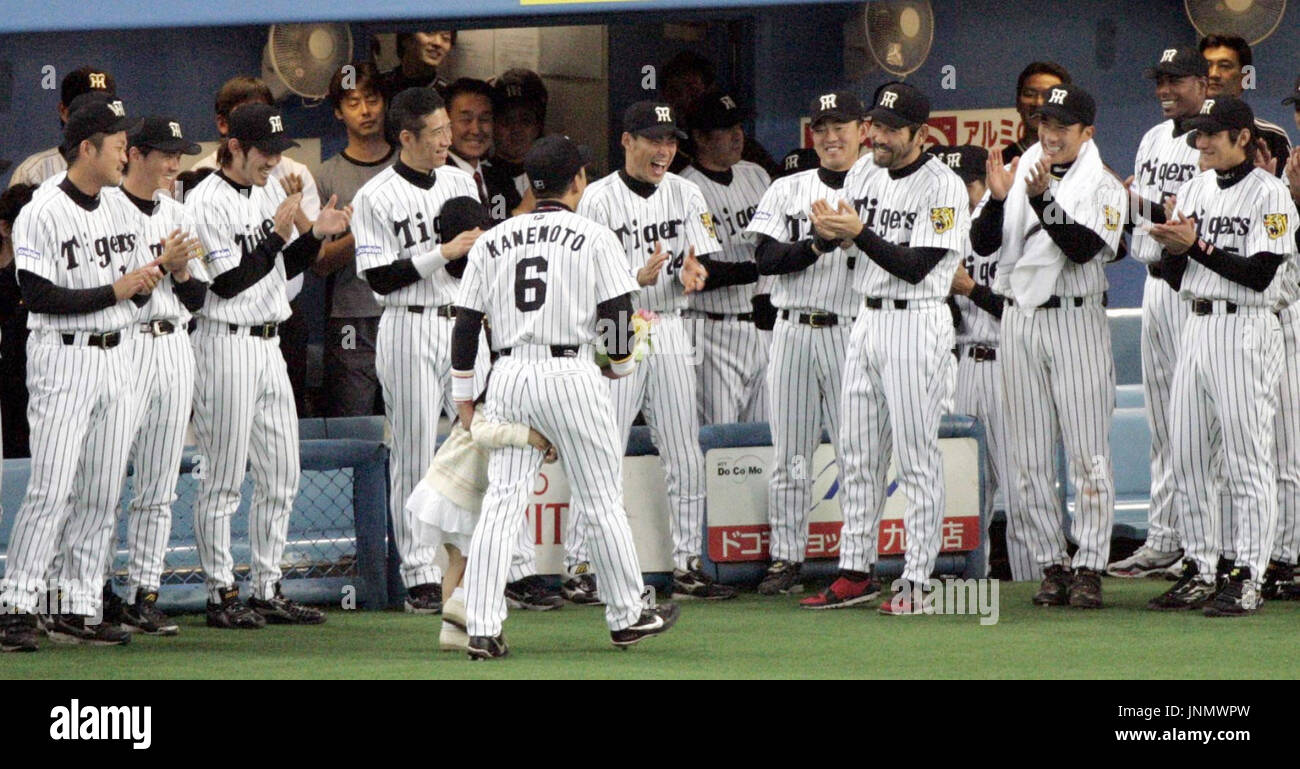 OSAKA, Japan - Hanshin Tigers members celebrate Tomoaki Kanemoto (6) at Osaka Dome on April 9 ...