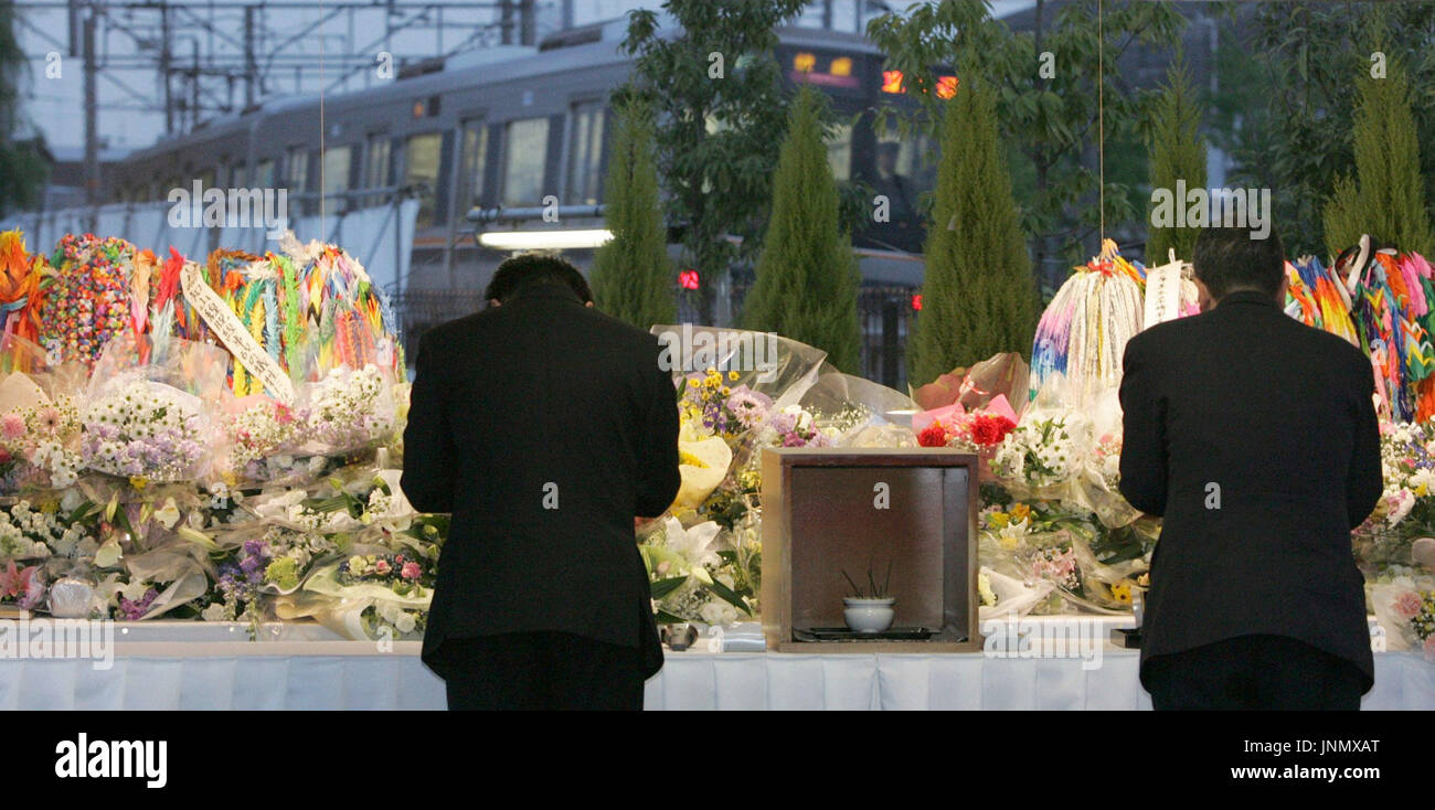 AMAGASAKI, Japan - Relatives pray for the victims of a commuter train derailment on West Japan ...