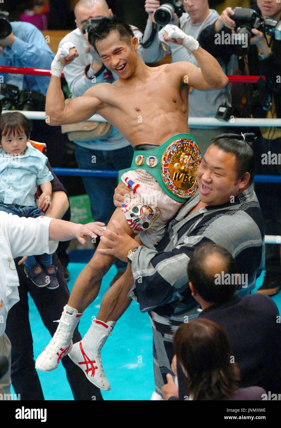 TOKYO, Japan - Thai champion Eagle Kyowa is lifted up by Japanese sumo ...