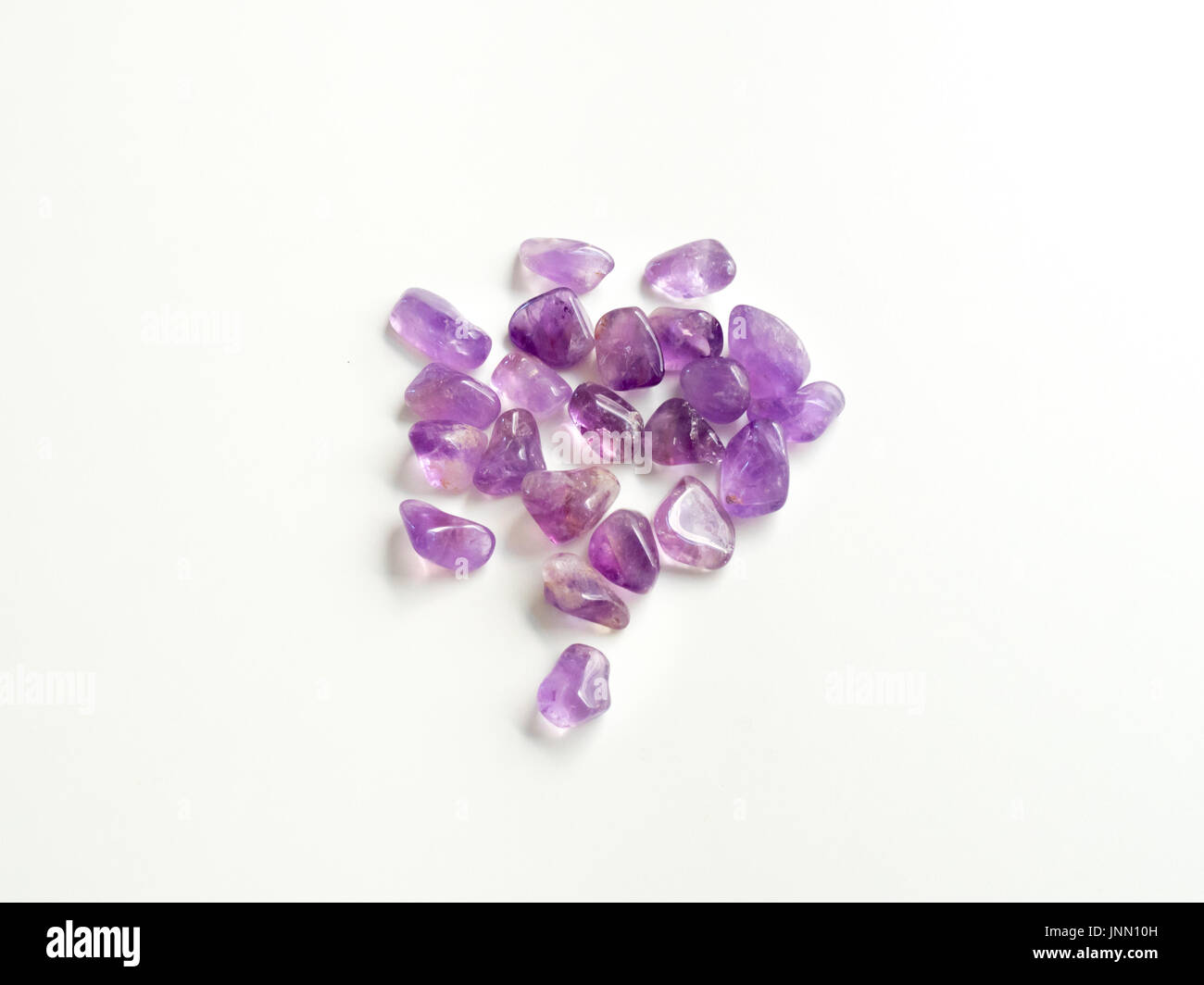 Tumbled Amethyst stones close up from top for crystal therapy ...