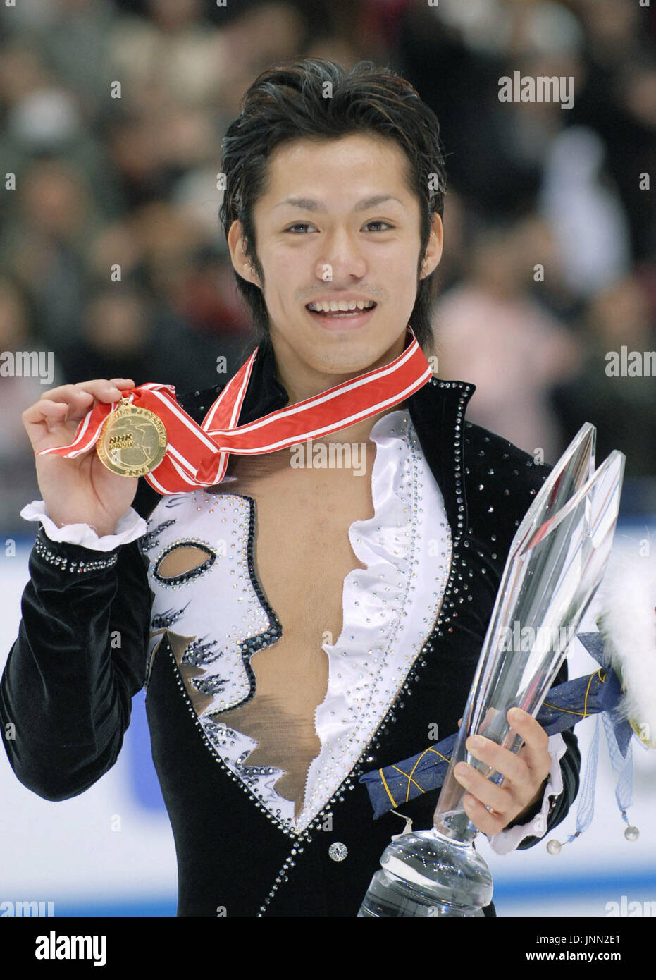 NAGANO, Japan - Daisuke Takahashi of Japan holds up his gold medal after winning the men's NHK ...