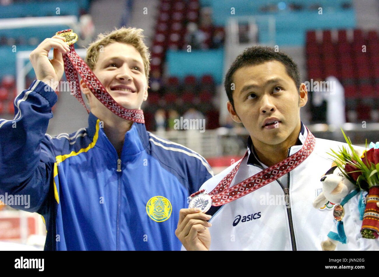 DOHA, Qatar - Kazakhstan's Vladislav Polyakov (L) shows off his Asian Games men's 50-meter ...