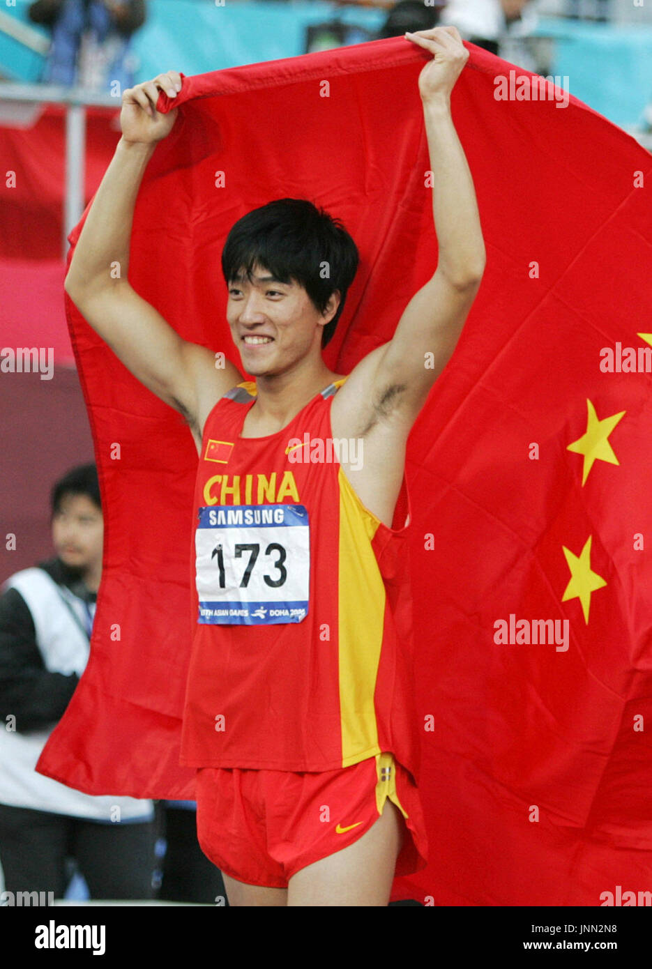 DOHA, Qatar - China's Liu Xiang holds up a Chinese flag at Khalifa ...