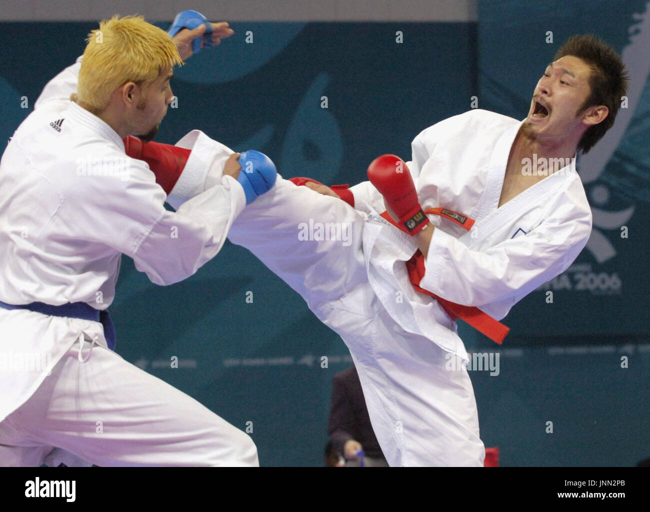 DOHA, Qatar - Ryosuke Shimizu of Japan (R) kicks at Ahmad Mohammed of ...