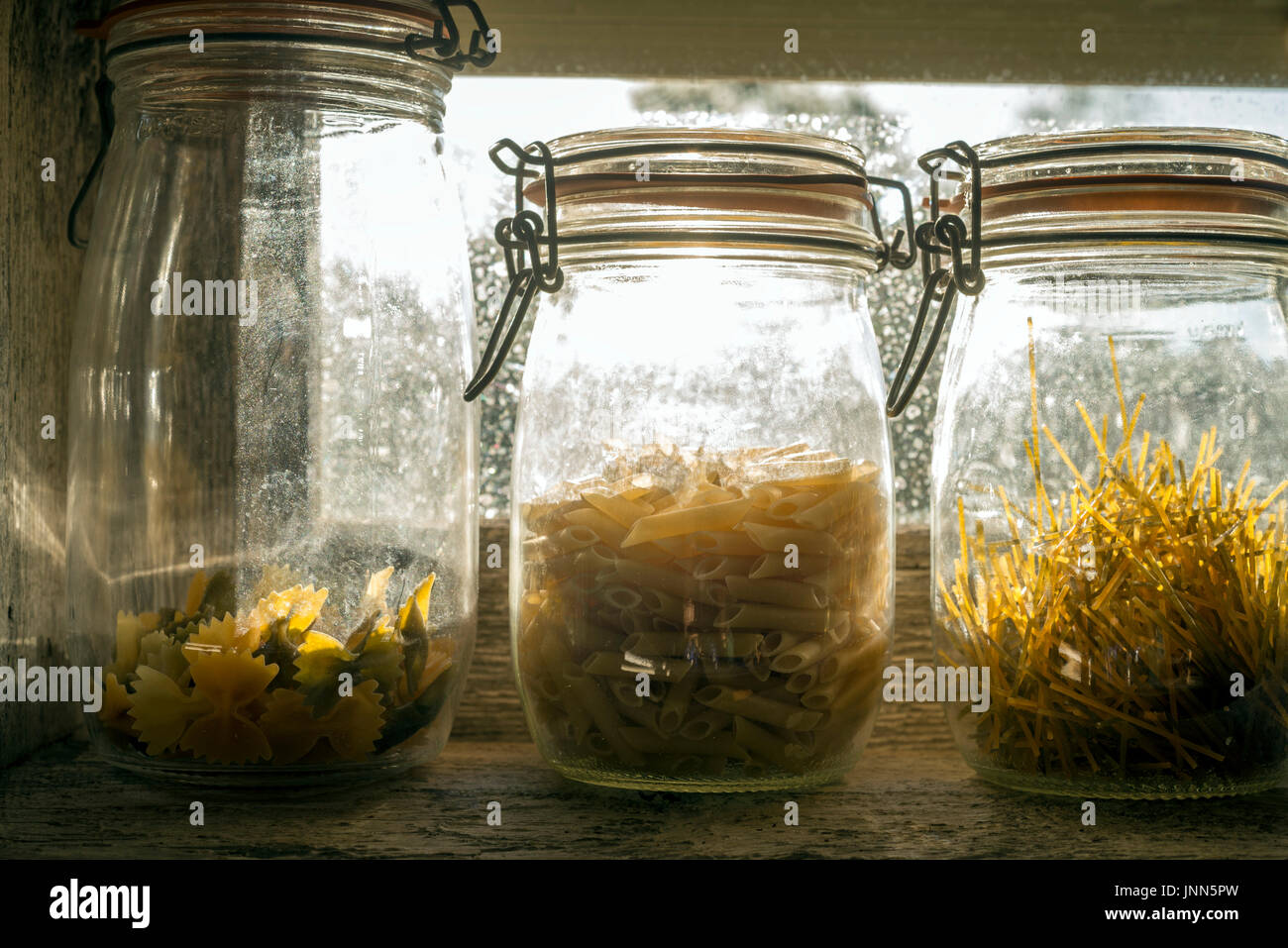 Three glass jars with paste in a window Stock Photo - Alamy