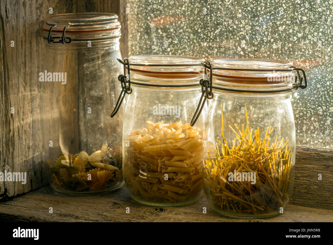 Three glass jars with paste in a window Stock Photo - Alamy