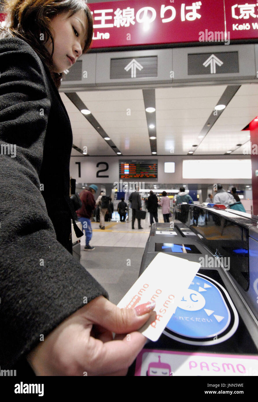 TOKYO, Japan - A woman passes a ticket barrier March 18 using the Pasmo ...
