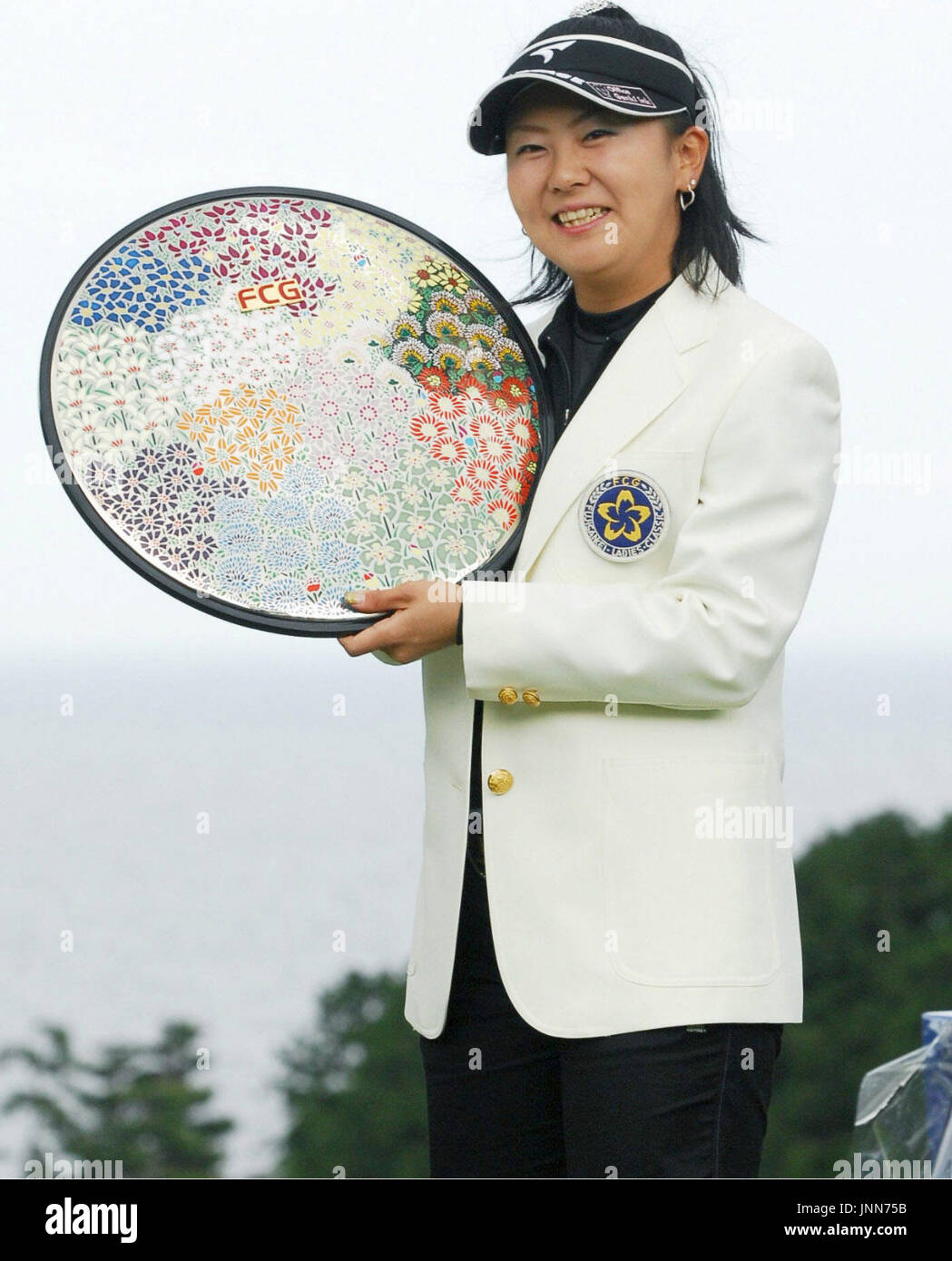 ITO, Japan - Tour rookie Miki Saiki shows off her victory plaque after ...