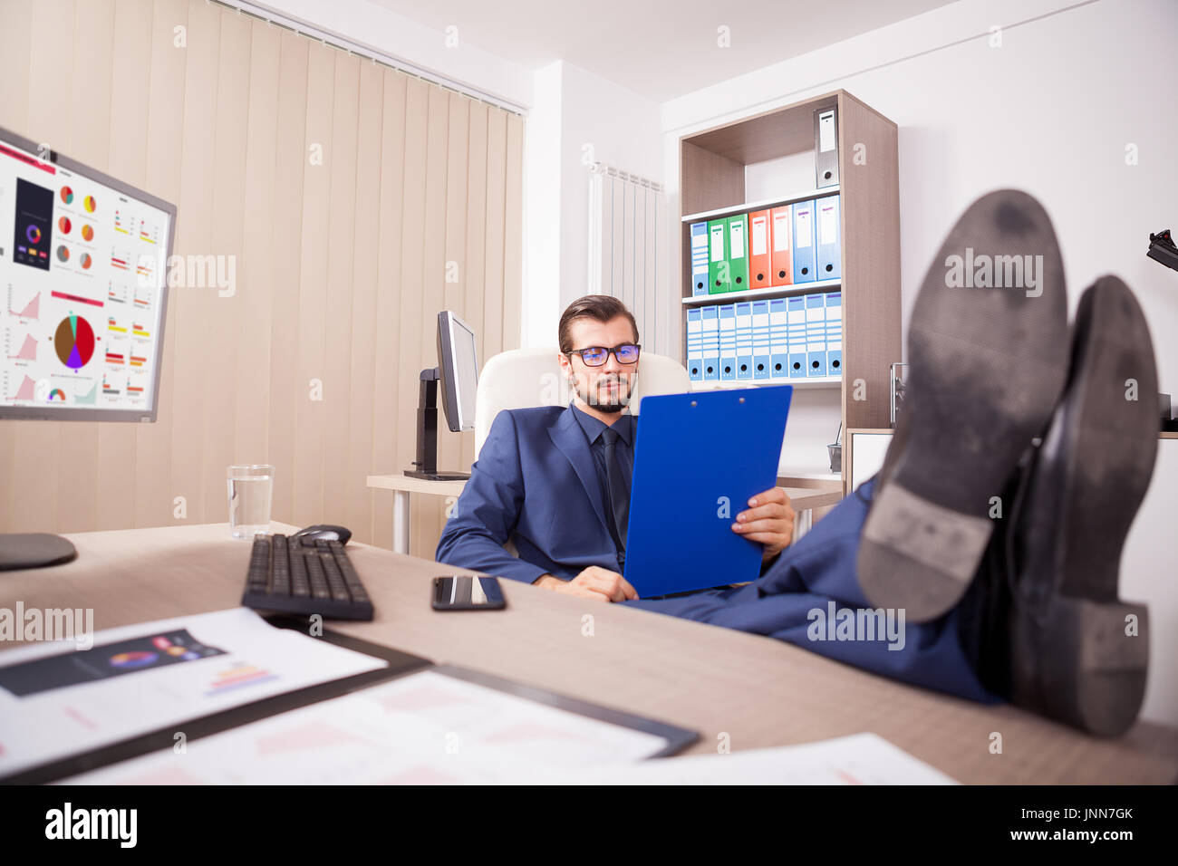 Boss in office feet up on desk hi-res stock photography and images - Alamy