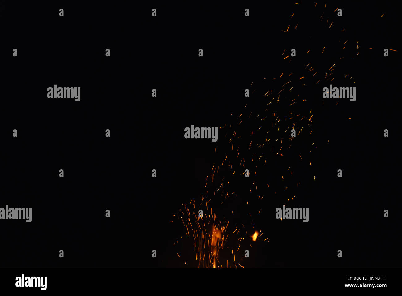 hot spark from campfire over night sky Stock Photo - Alamy