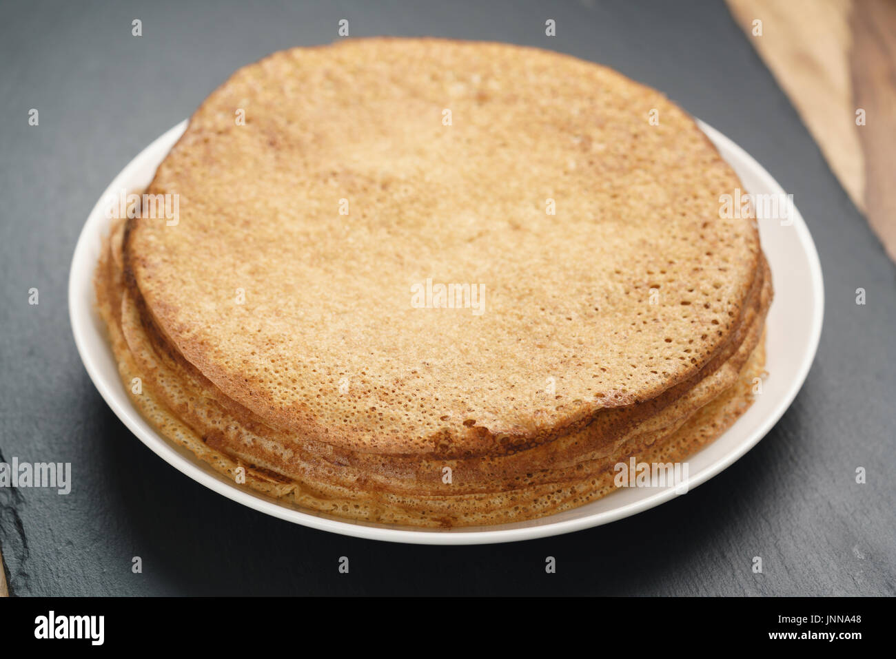 homemade blini stack on plate on slate board Stock Photo - Alamy
