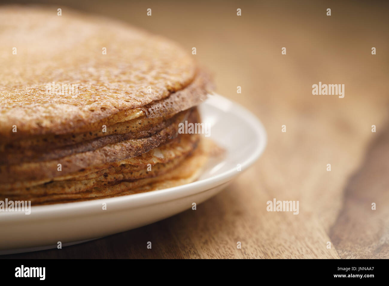homemade blini stack on plate on wood table Stock Photo - Alamy