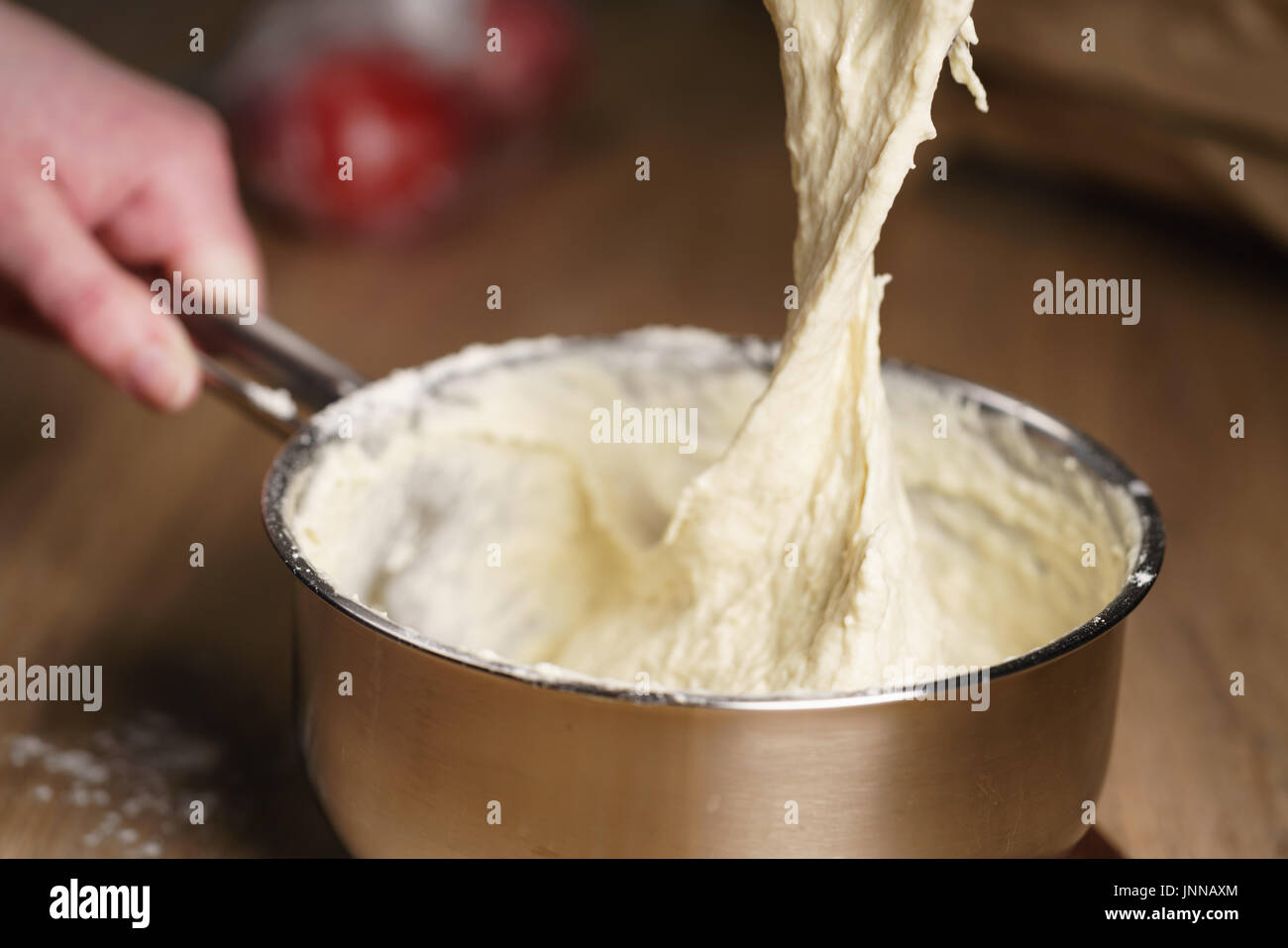 female hands mixing sticky dough Stock Photo - Alamy