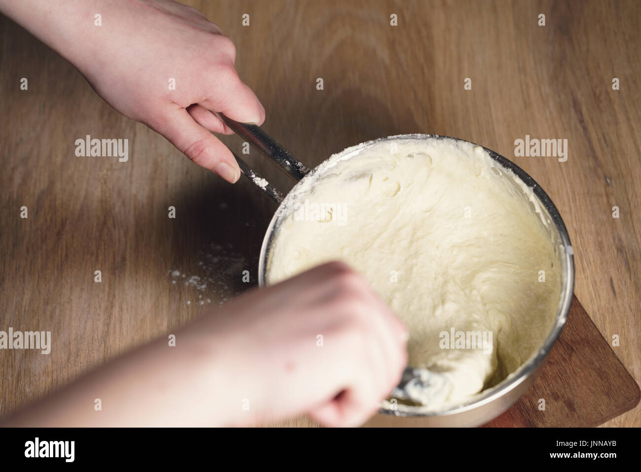 female hands mixing sticky dough Stock Photo - Alamy
