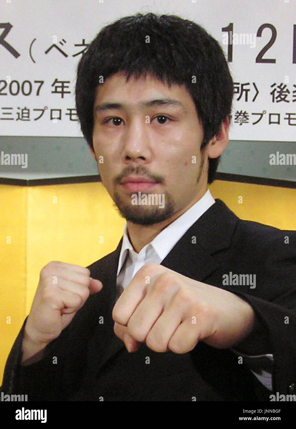 TOKYO, Japan - Japanese boxer Kuniyuki Aizawa poses during a press ...