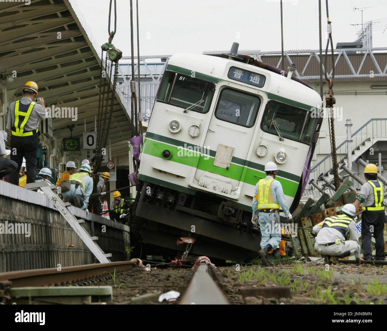 KASHIWAZAKI, Japan - East Japan Railway Co. employees work to put a ...