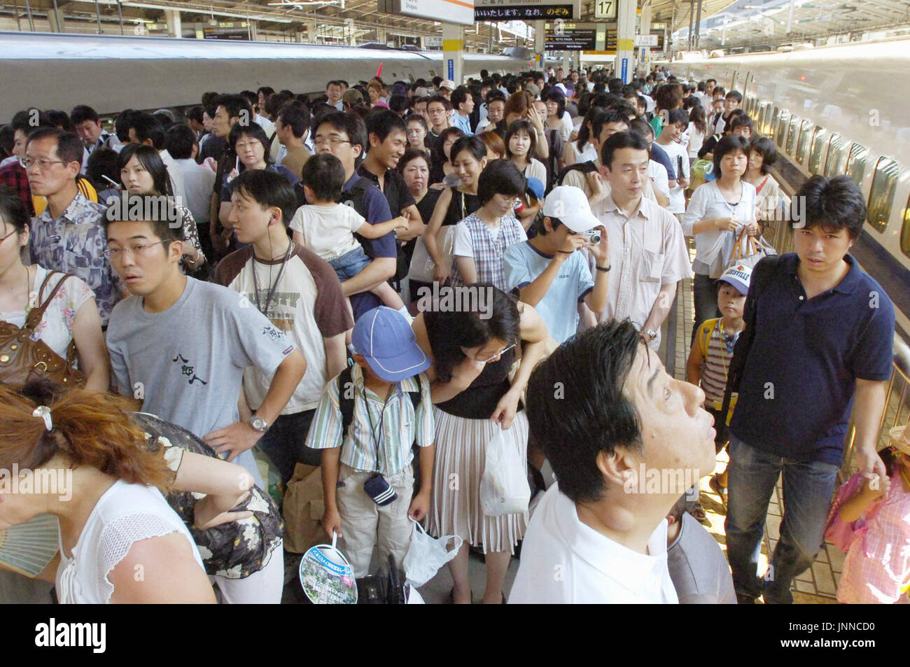 TOKYO, Japan - Travelers jam a Shinkansen bullet train platform at ...