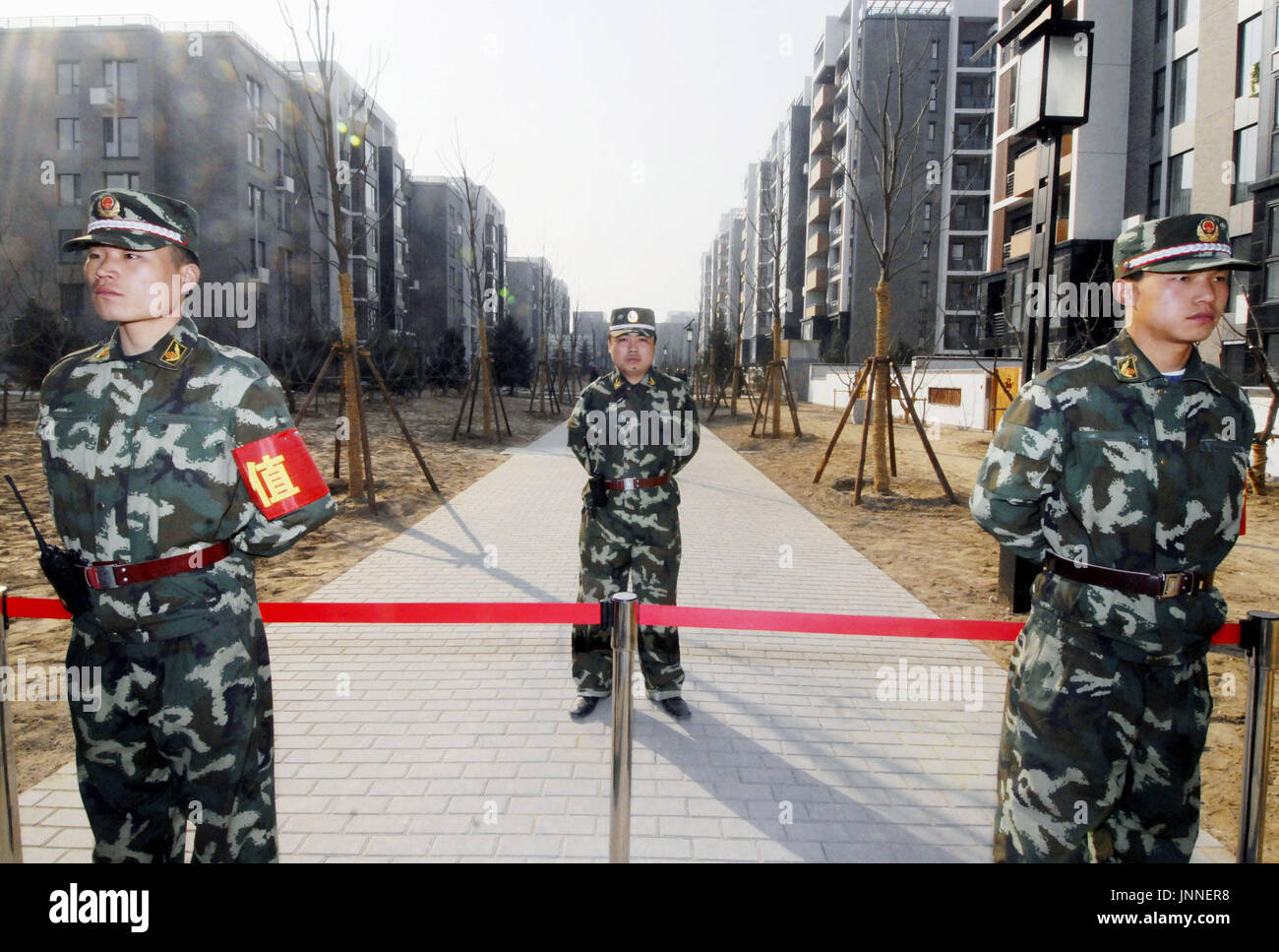 BEIJING, China - Police officers stand outside a block of apartments in ...