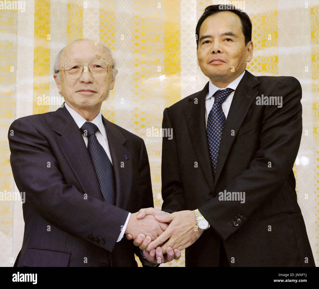 TOKYO, Japan - Aeon Co. President Motoya Okada (R) and CFS Corp ...