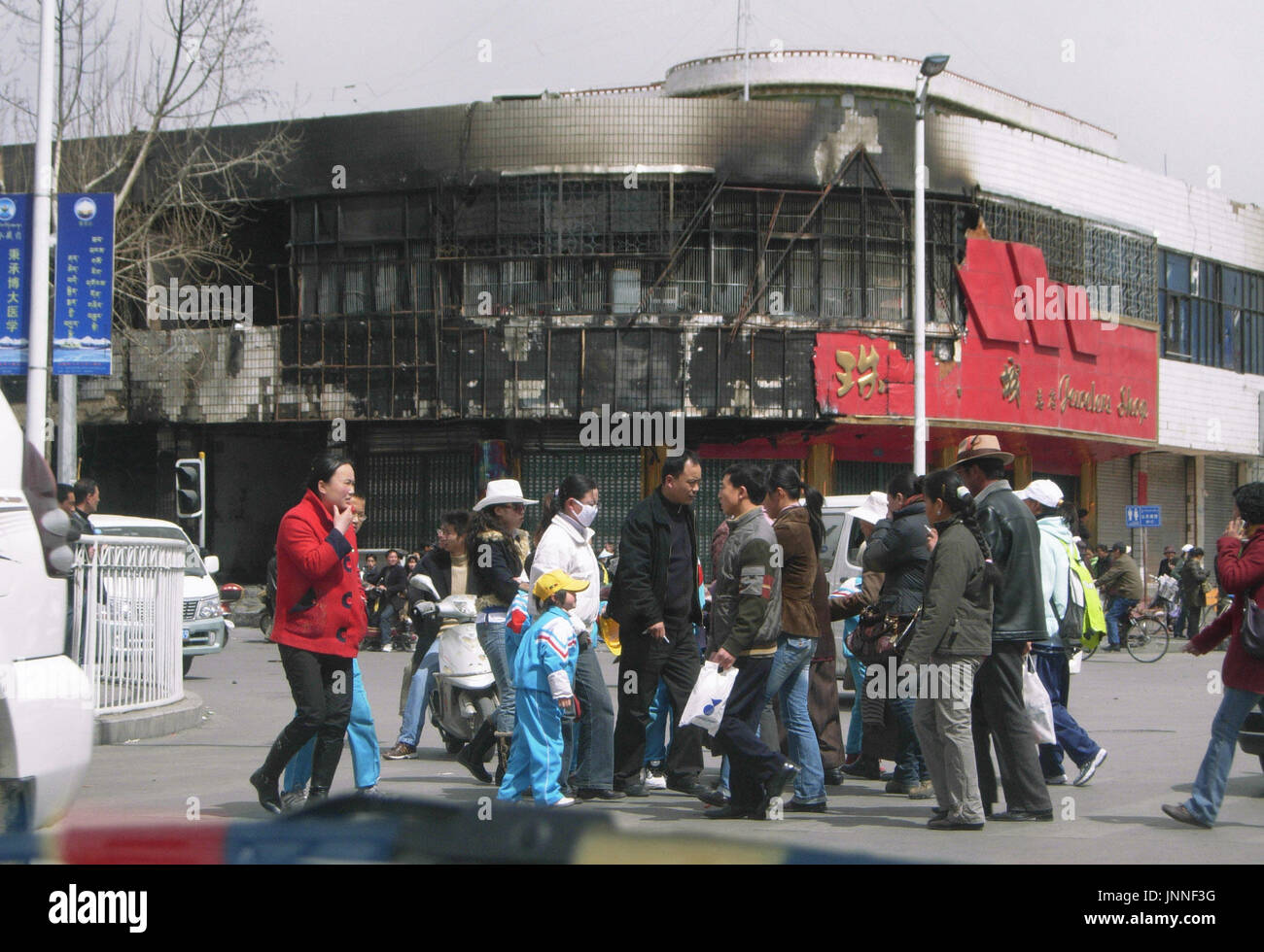 LHASA, China - People pass in front of a burnt-out store on the Beijing ...