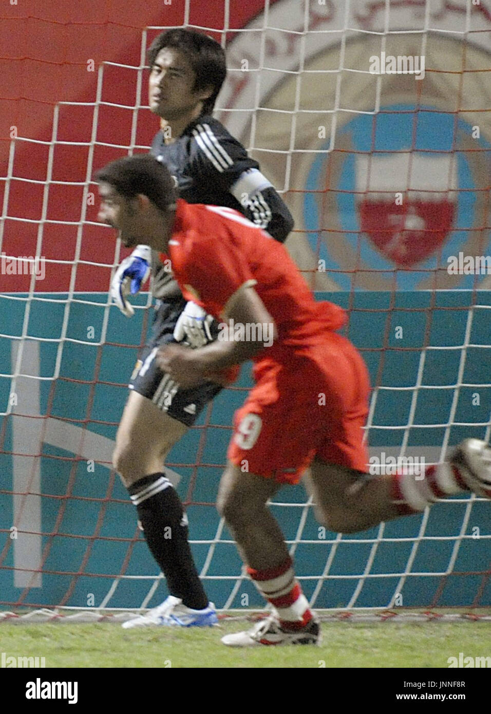MANAMA, Bahrain - Japan goalkeeper Yoshikatsu Kawaguchi (back) looks ...