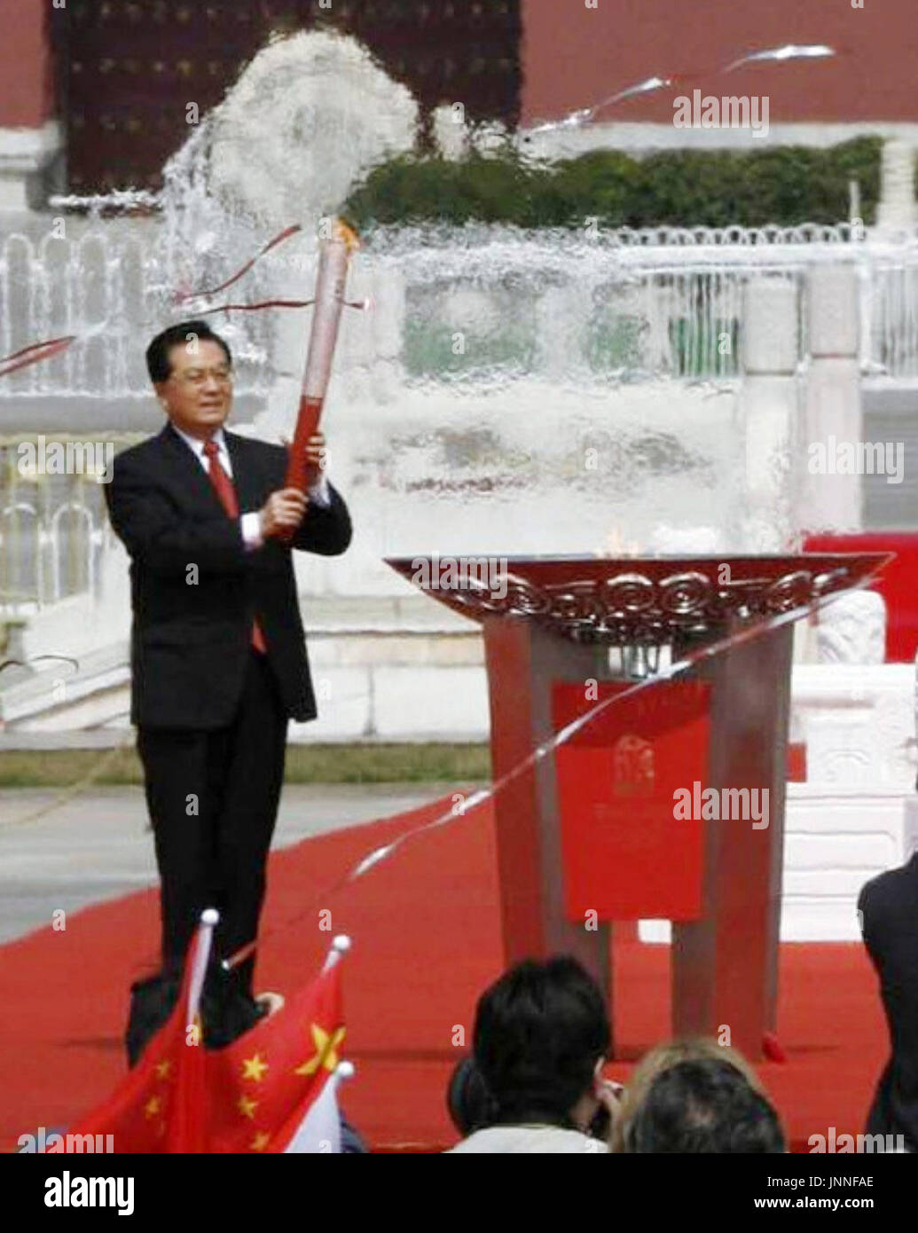 BEIJING, China - Chinese President Hu Jintao holds up the Olympic torch ...