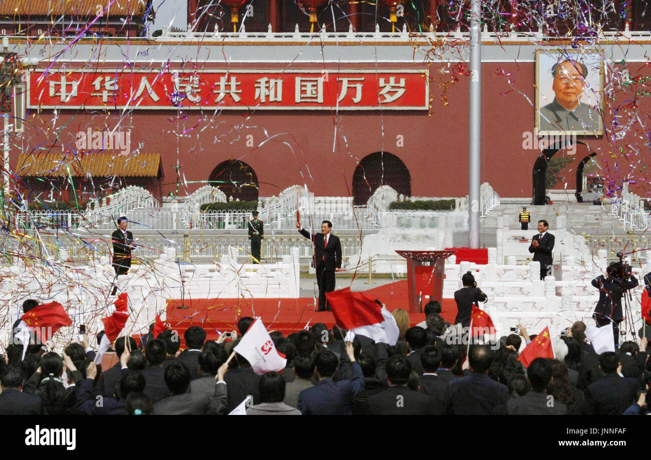 BEIJING, China - Chinese President Hu Jintao (C) holds up the Olympic ...