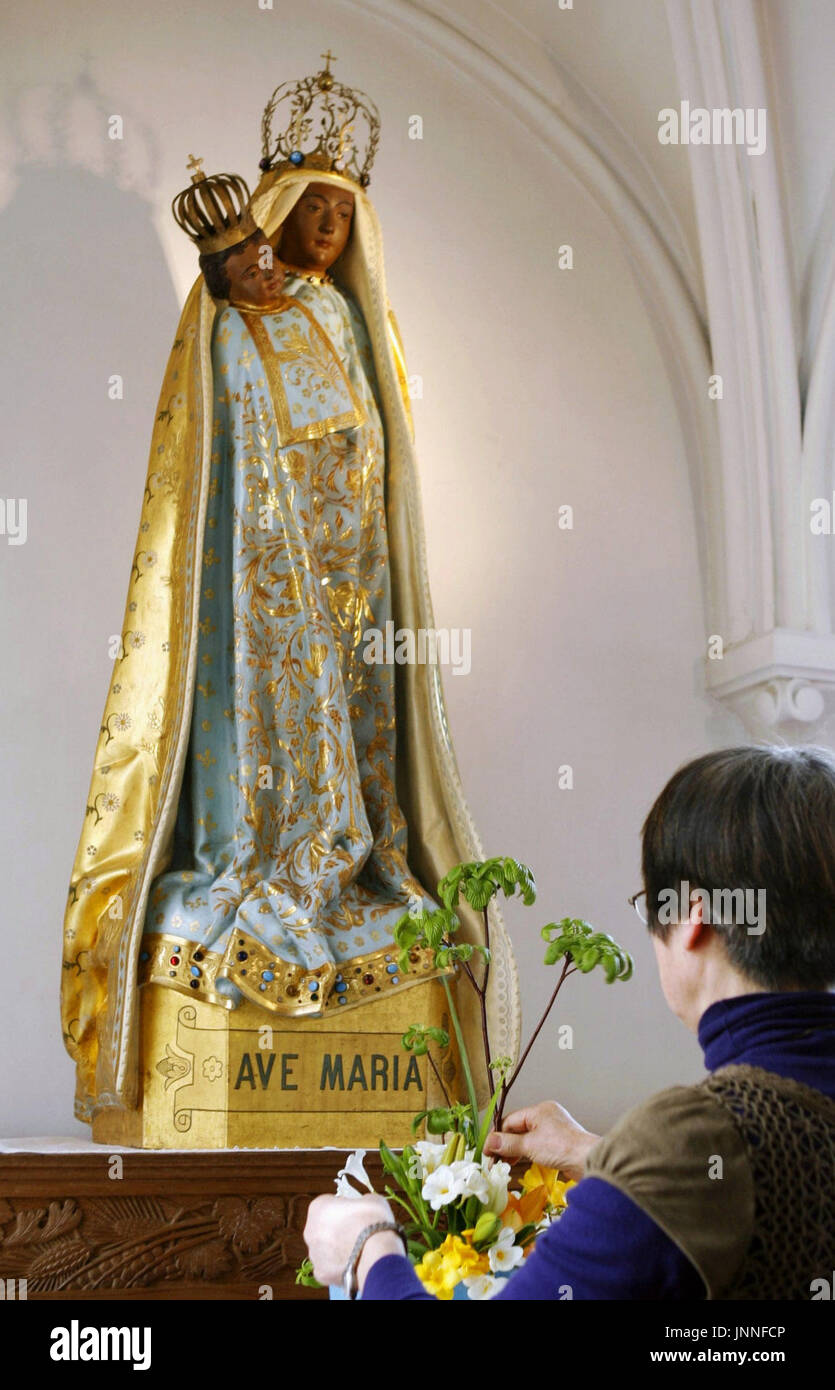 TSURUOKA, Japan - A Catholic worshipper offers flowers to the renovated ...