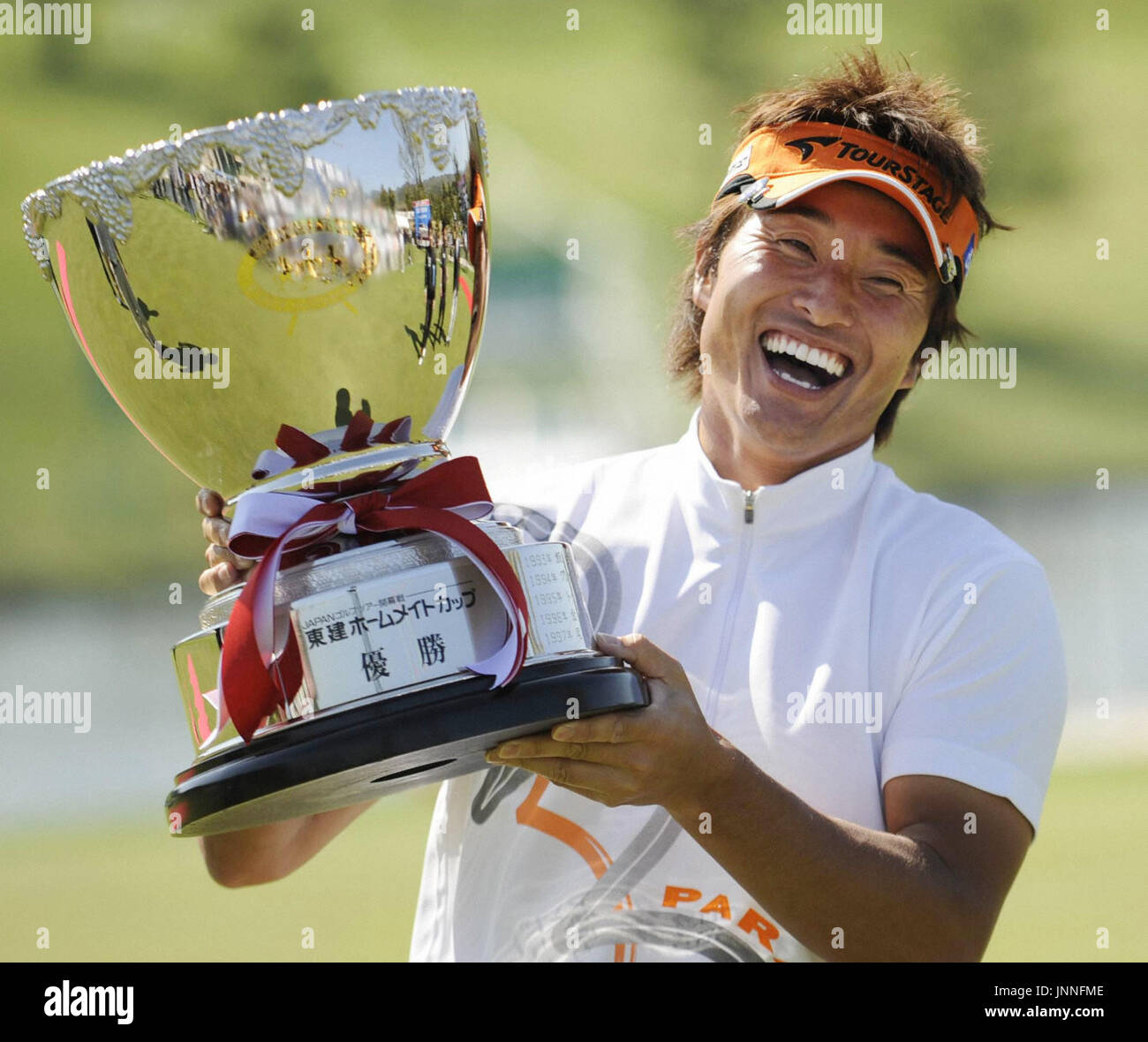 KUWANA, Japan - Katsumasa Miyamoto smiles with the winner's trophy ...