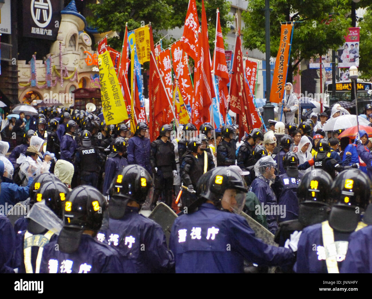 TOKYO, Japan - Riot police surround protesters marching in Tokyo on ...