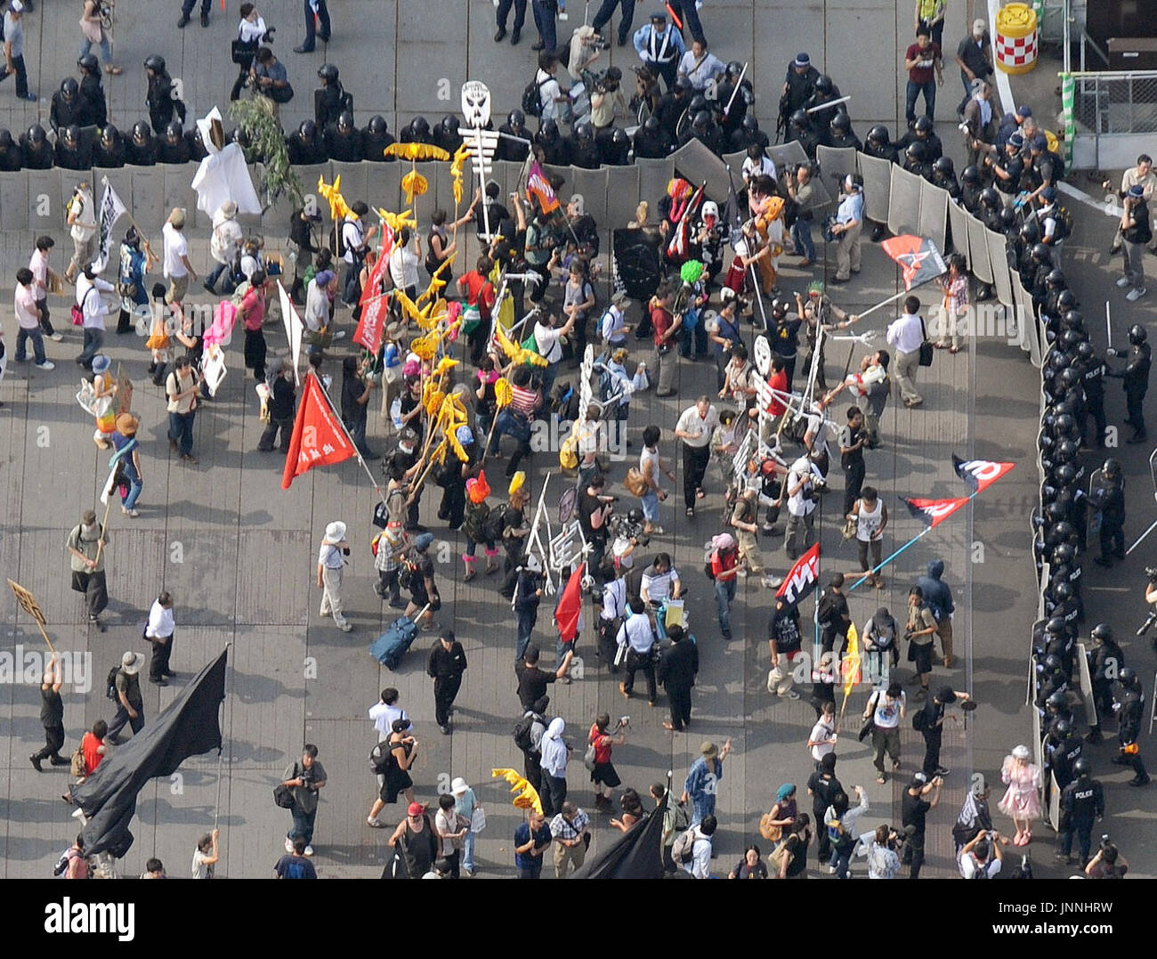 SAPPORO, Japan - Riot police surround members of nongovernmental ...