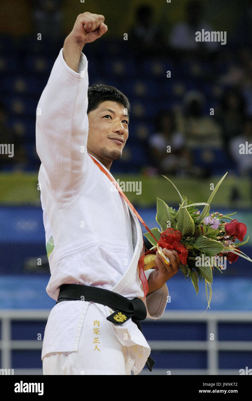 BEIJING, China - Masato Uchishiba raises his hand in victory at the ...