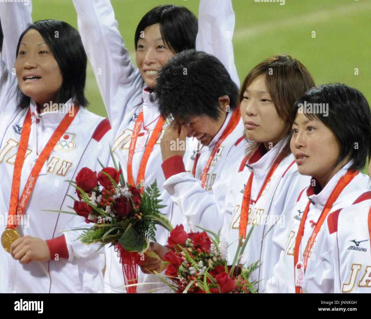 BEIJING, China - Japan softball pitcher Yukiko Ueno (C) wipes away ...