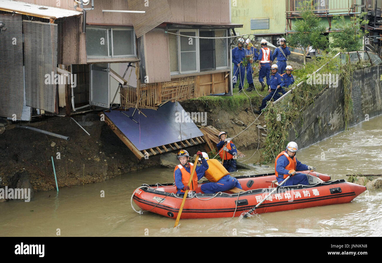 TOKYO, Japan - Firefighters search for an 80-year-old woman in the Iga ...