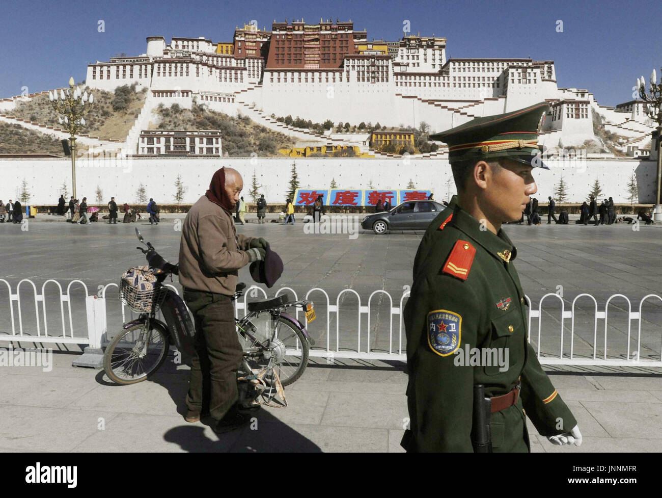 LHASA, China - A military police officer walks in a square in front of ...